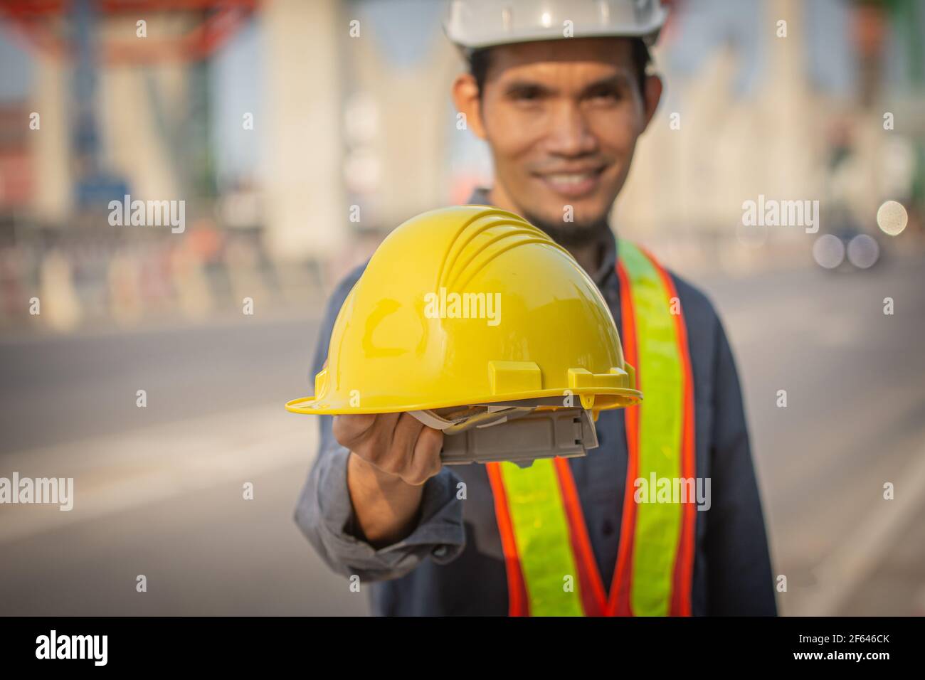 Engineer holding helmet on site Road construction For the development ...