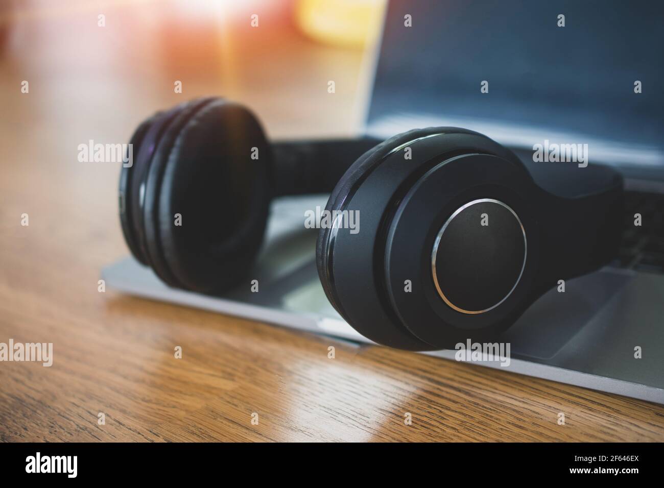 Headphone on laptop computer for listening music Stock Photo - Alamy