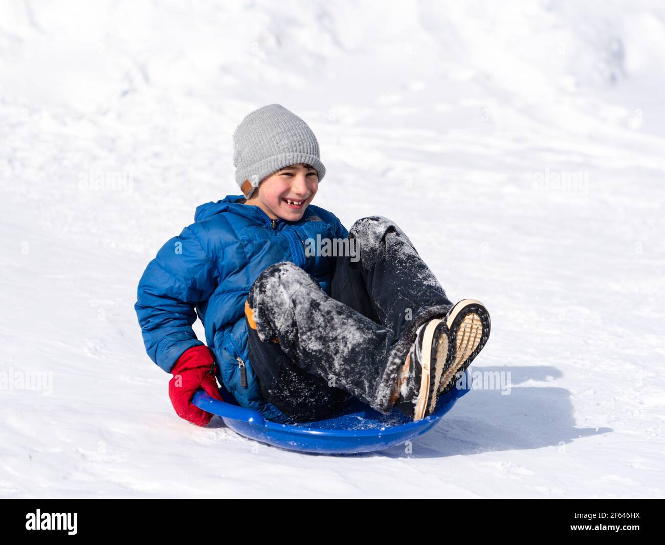 Kid snow gliding Stock Photo - Alamy