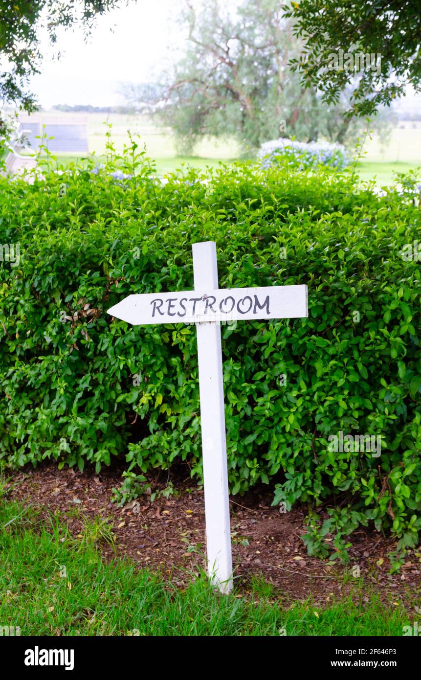 Sign pointing to Restroom Stock Photo - Alamy