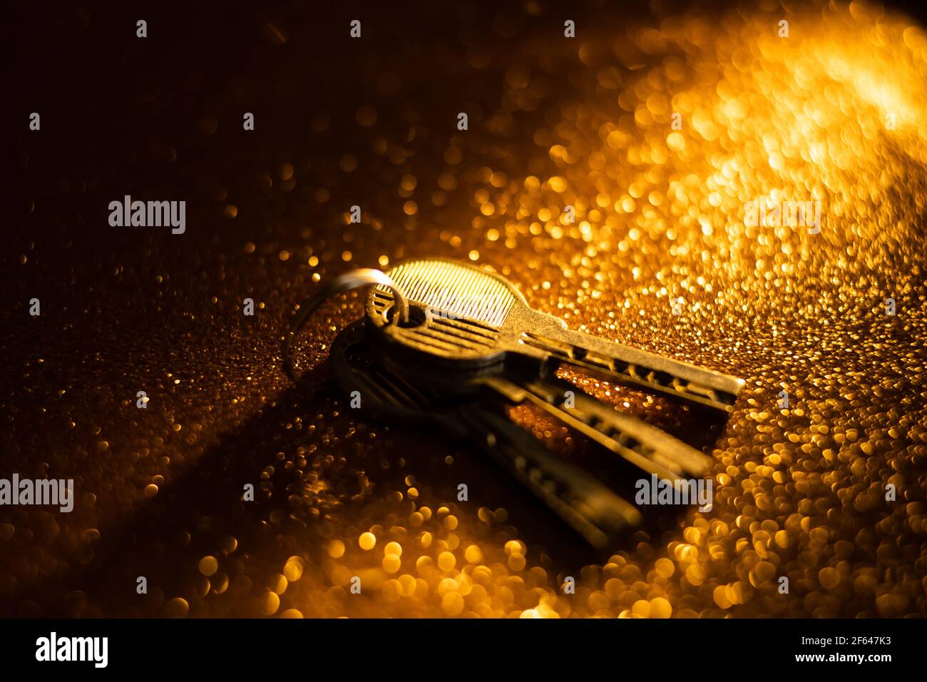 Keys on gold background Stock Photo - Alamy
