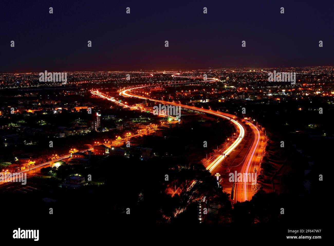 Night aerial view of the Lanyang Plain, with car light trails at night ...