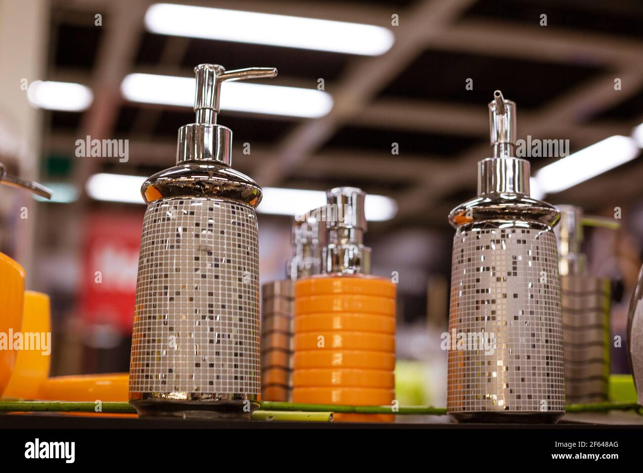 dispenser for liquid soap from glass on a shelf in a store, close-up ...