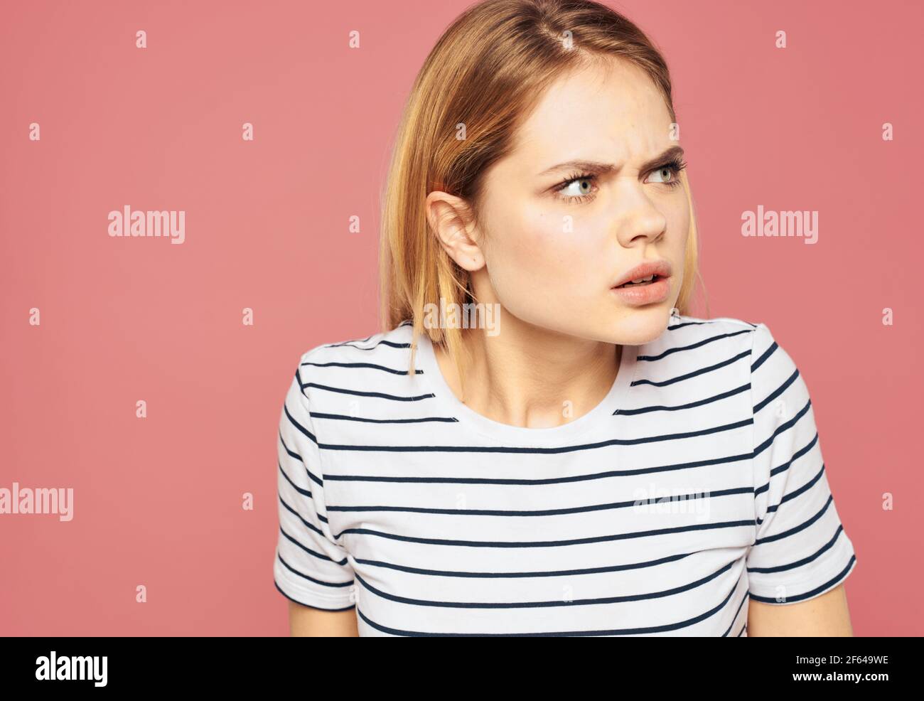Upset woman offended face pink background cropped view model Stock ...