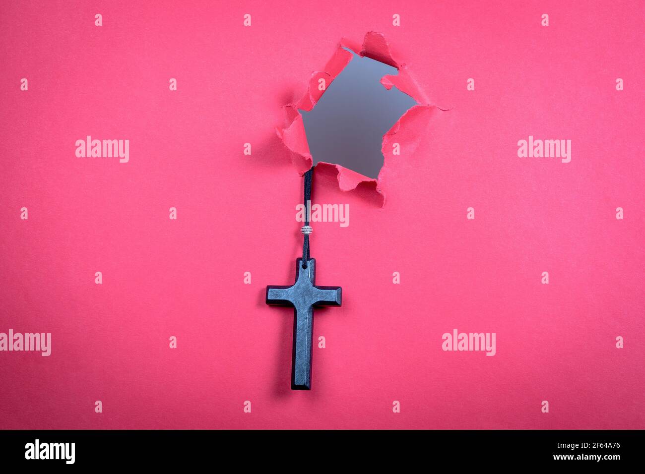 Religion, belief and conviction concept. Wooden cross on a red ...