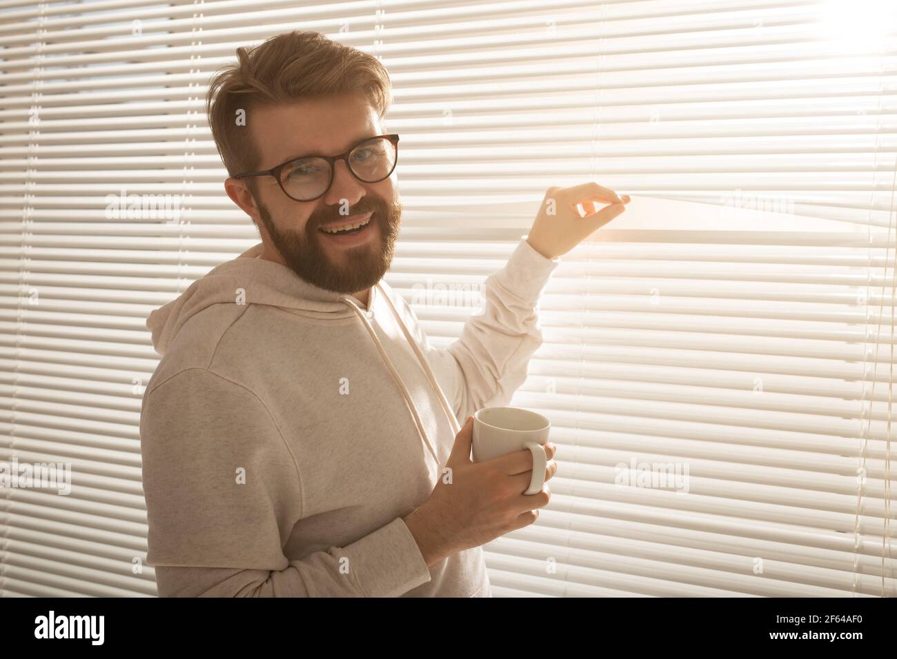 Man peeking out window hi-res stock photography and images - Alamy