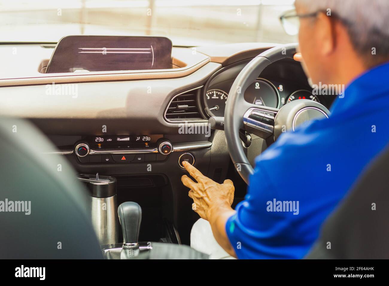 Man starts the car engine with start-stop button Stock Photo - Alamy