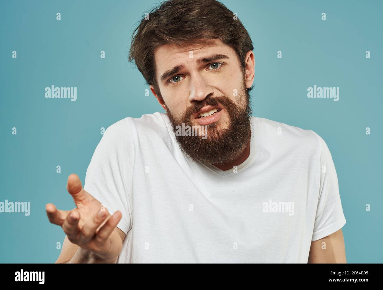 upset man on blue background cropped view Copy Space Model Stock Photo ...