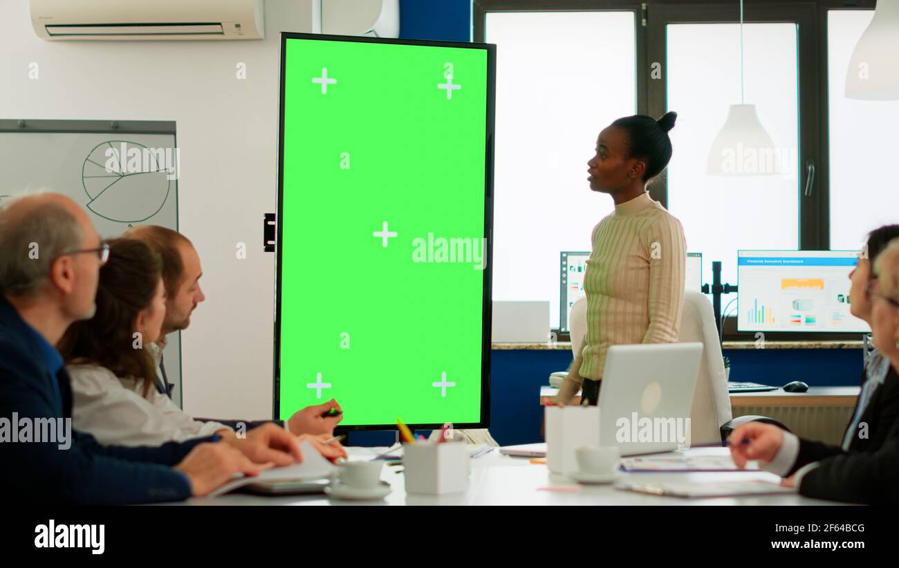 African businesswoman analysing annual financial reports standing in ...