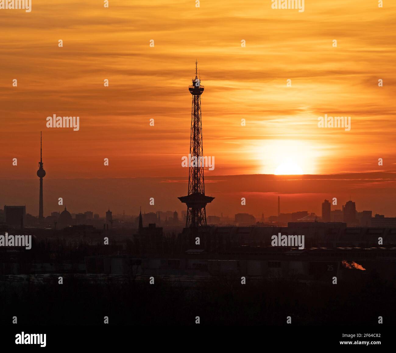 Berlin, Germany. 30th Mar, 2021. The rising sun colours the sky above ...