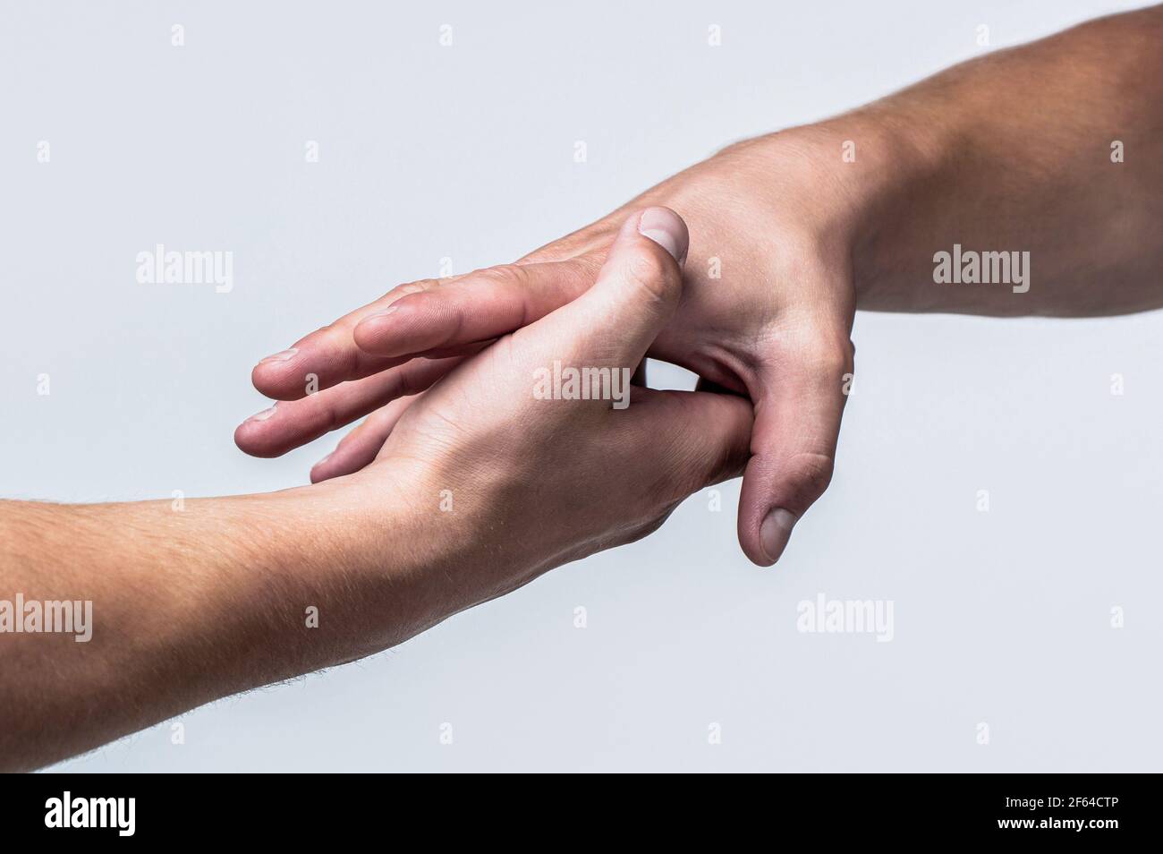 A friendly handshake. Two hands, shaking hands. Two hands, helping arm ...