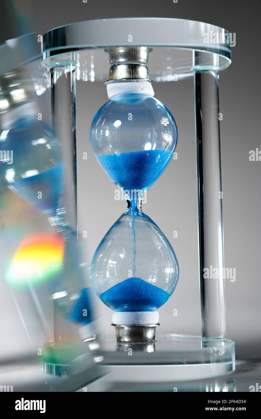 Shiny hourglass on blue background hi-res stock photography and images ...