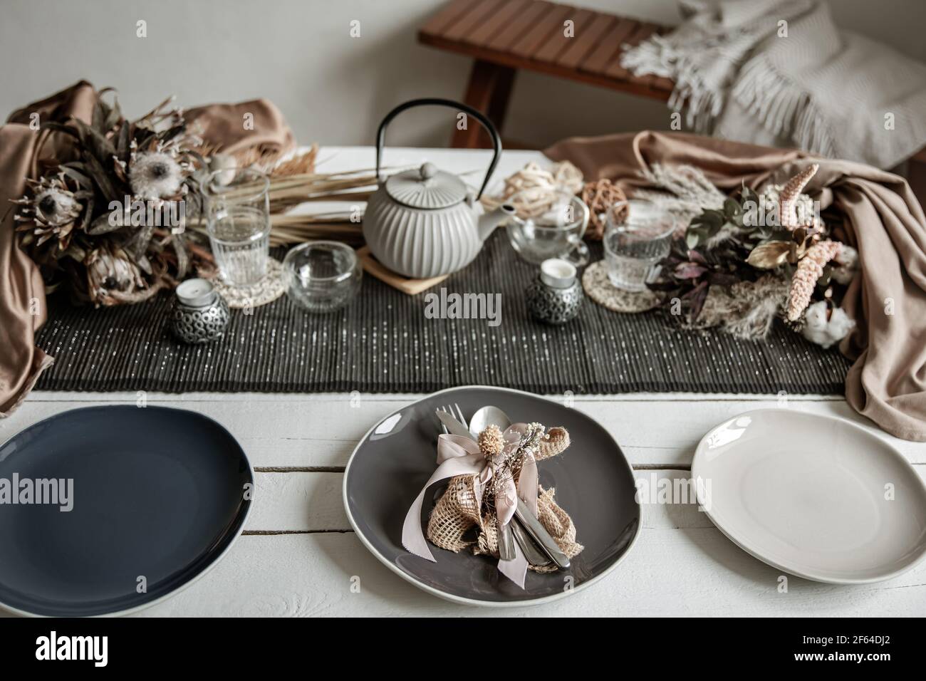 Stylish crockery and cutlery on a set table in coffee colors with ...