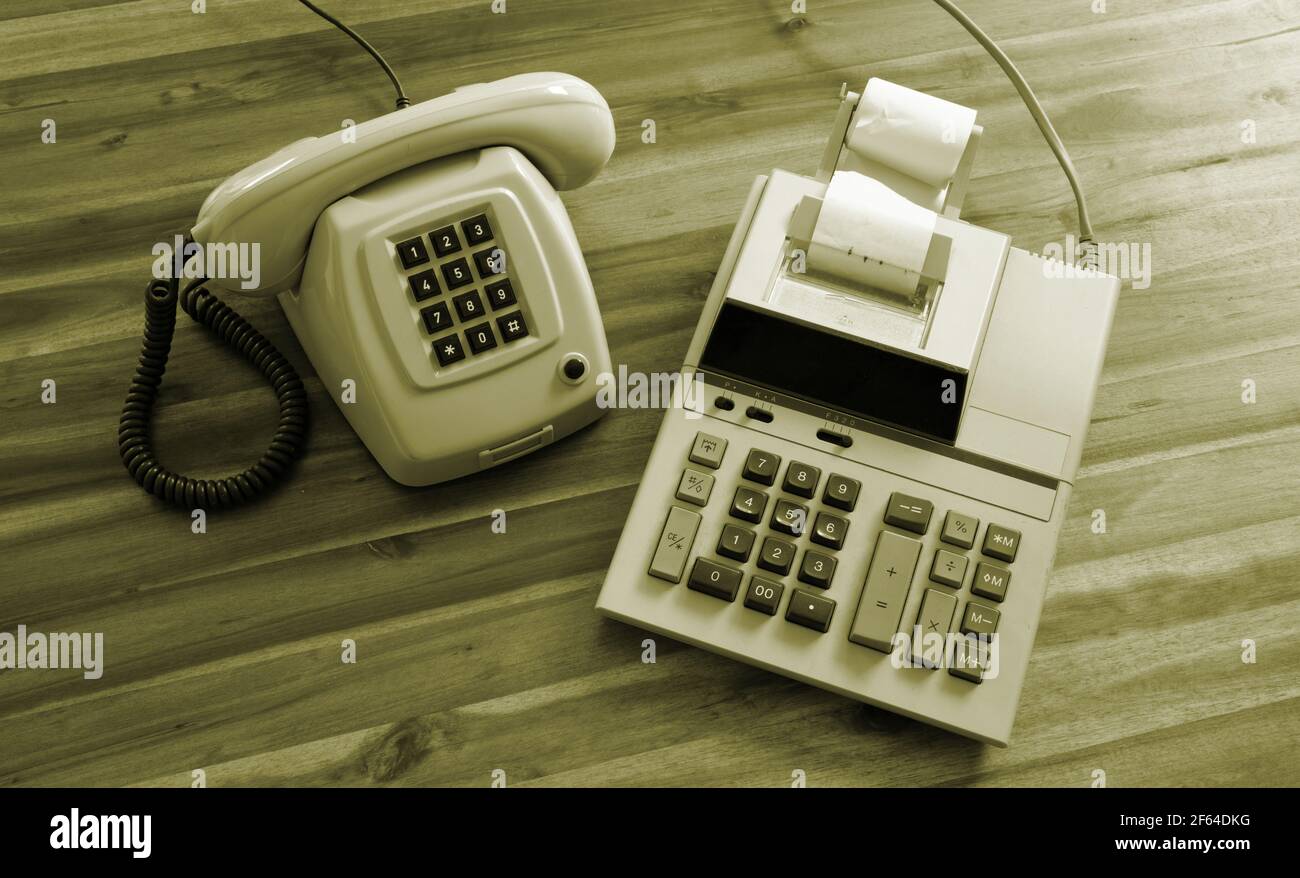 Old fashioned calculator and telephone on desk Stock Photo - Alamy