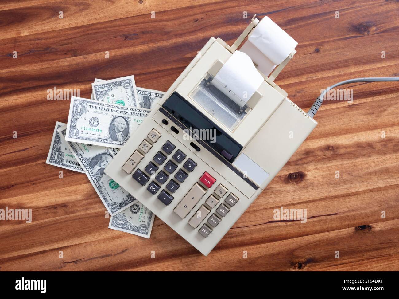 Old fashioned calculator and dollars on a desk Stock Photo - Alamy