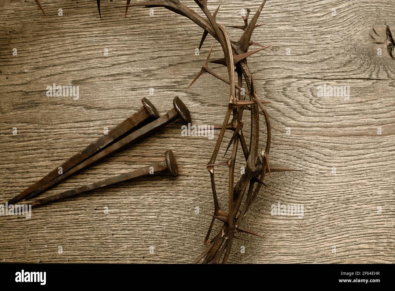 Crown of thorns with three nails on wooden background. Easter concept ...