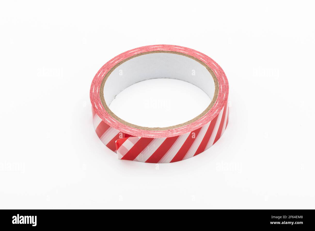 A roll of red and white striped sticking tape Stock Photo - Alamy