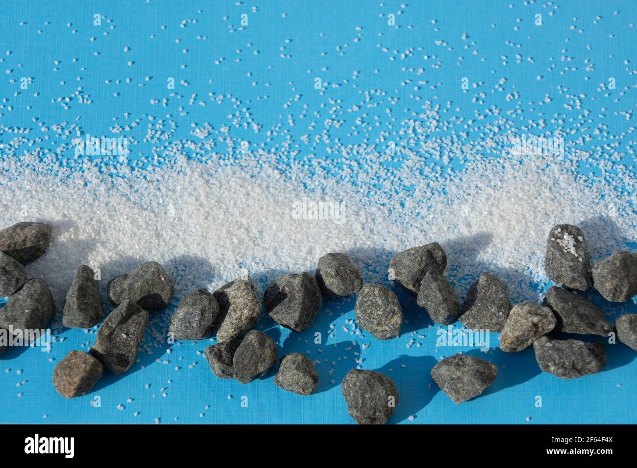 summer scene with stones and sand and blue paper sheet Stock Photo - Alamy