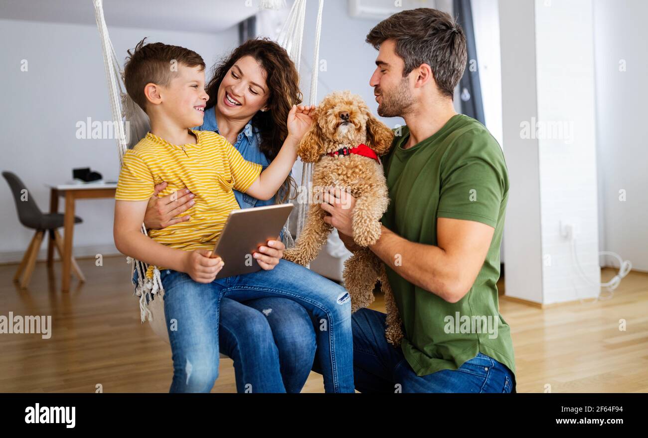 Happy family using technology devices together at home Stock Photo - Alamy
