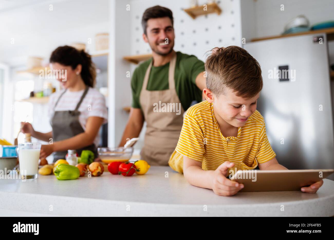 Happy family in the kitchen having fun and cooking together Stock Photo ...