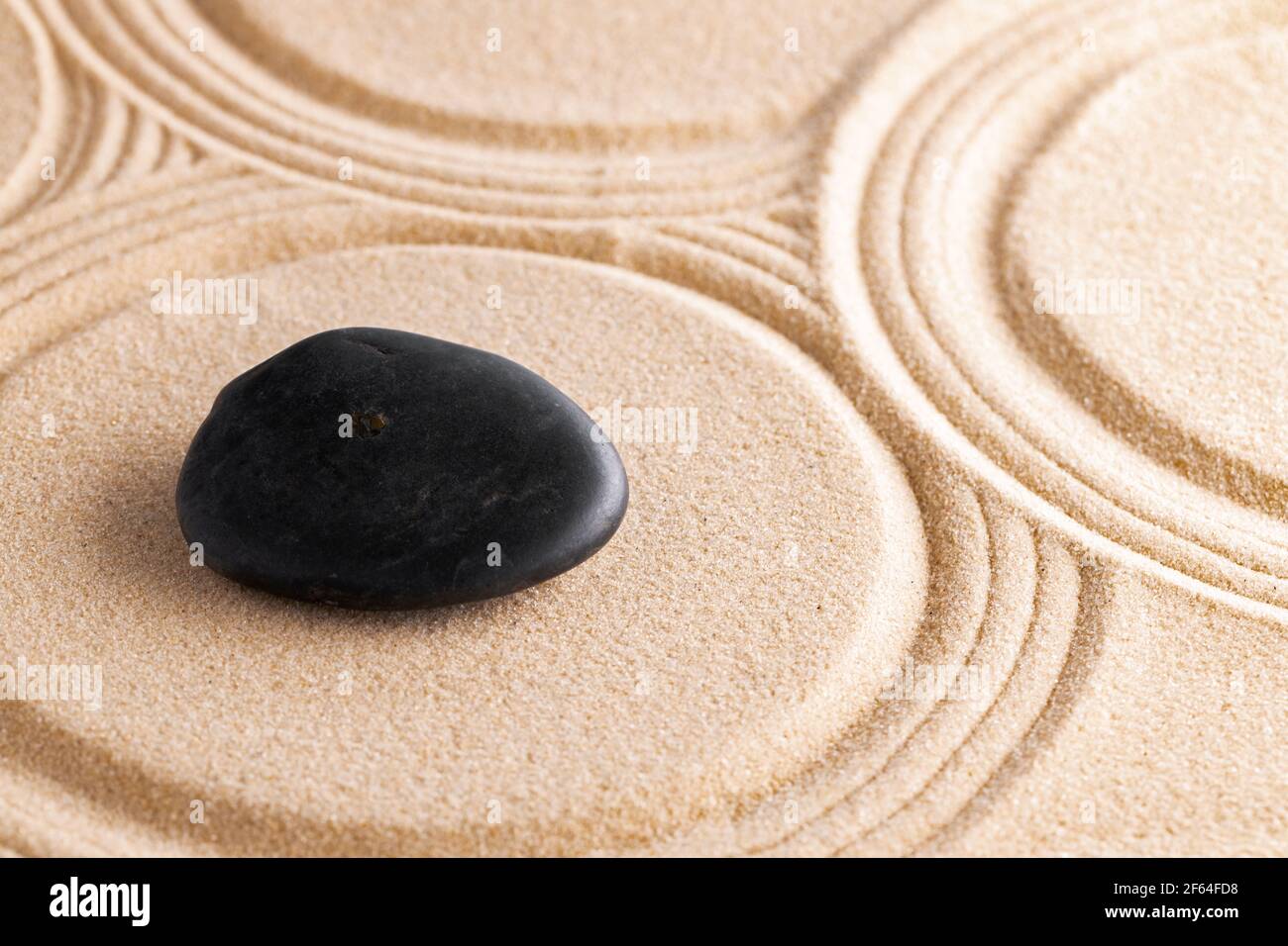 Japanese zen garden with stone in raked sand Stock Photo - Alamy