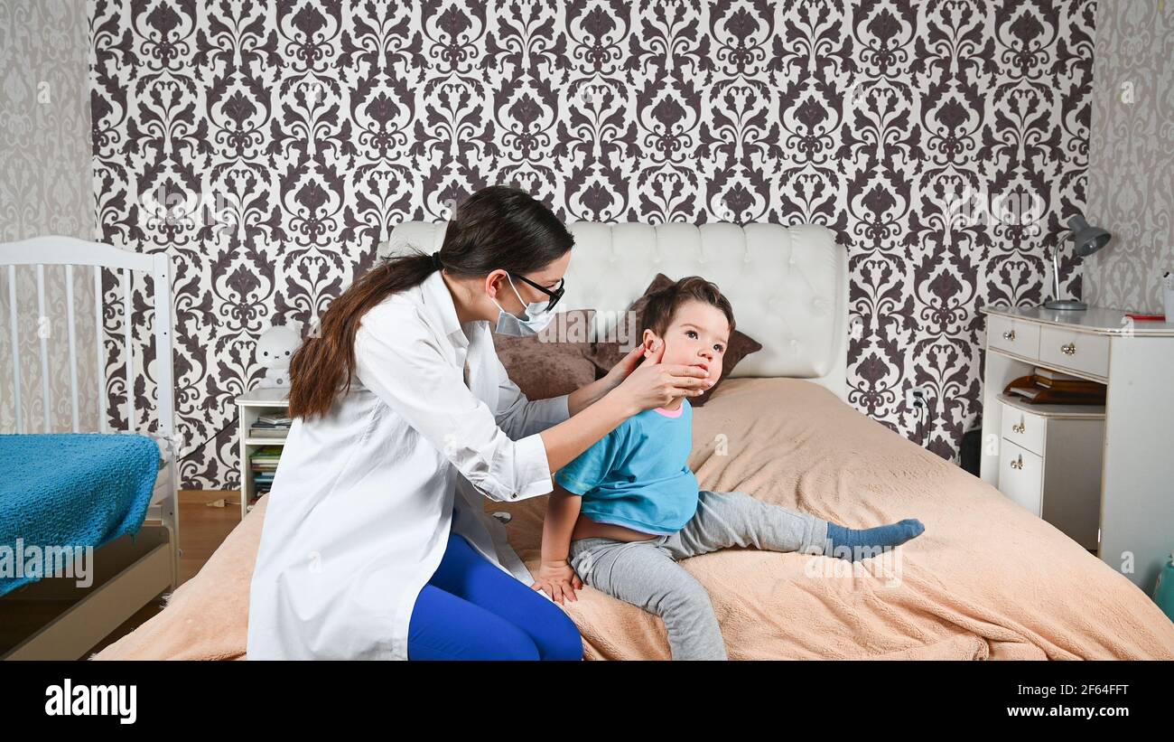 The doctor checks the child's ears at home Stock Photo - Alamy