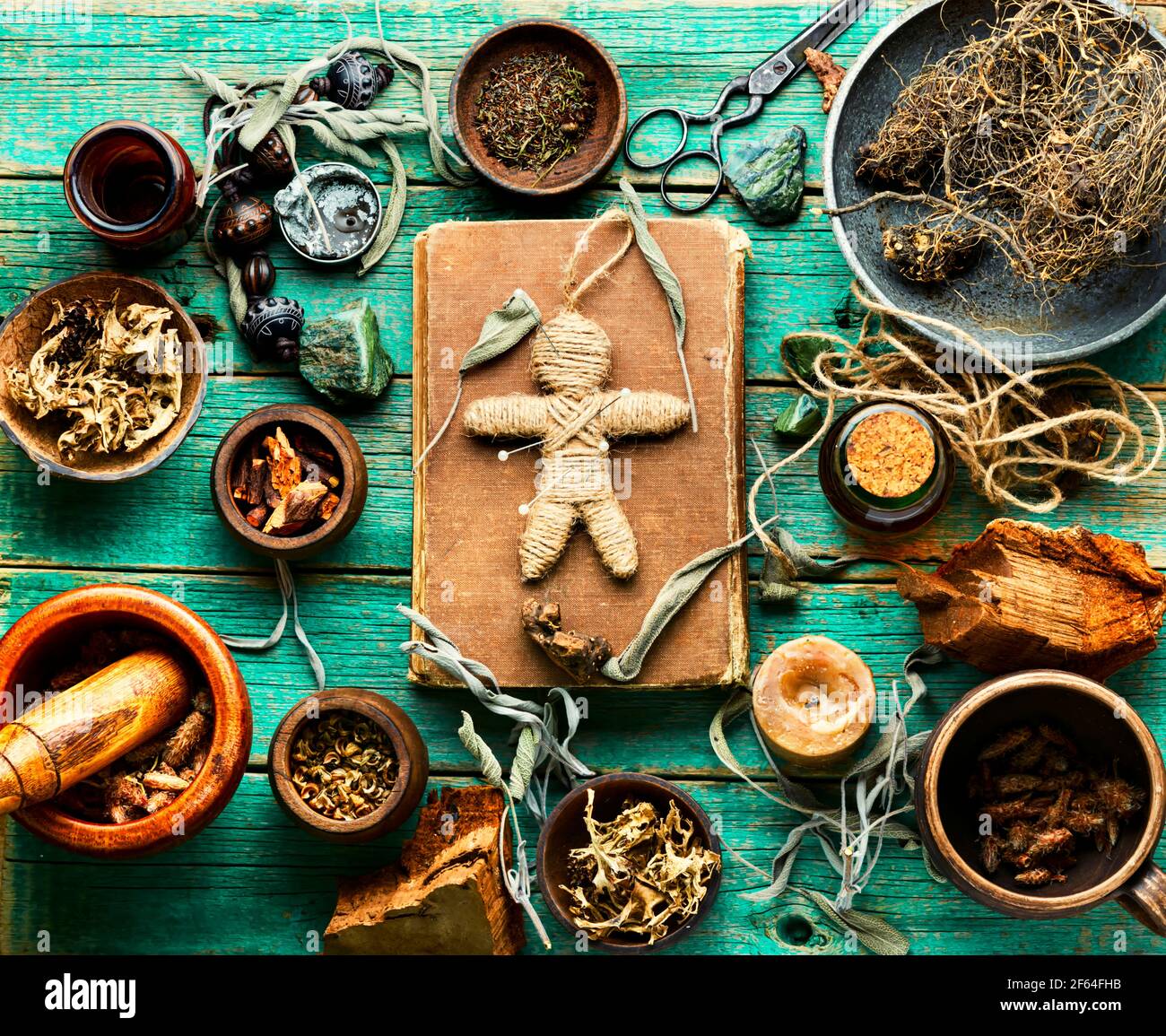 Voodoo doll,magical herbs and witchcraft attributes on an old table ...