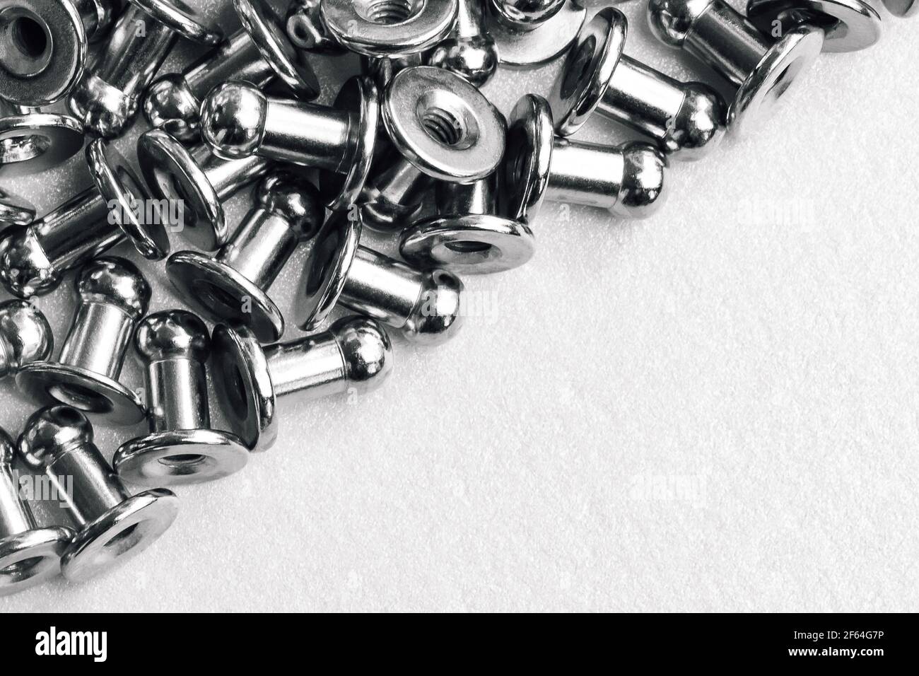 macro black and white background of sewing accessories-grommet, rivet ...