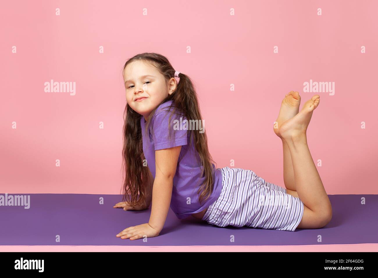 girl in profile doing morning exercises and stretching for the back ...
