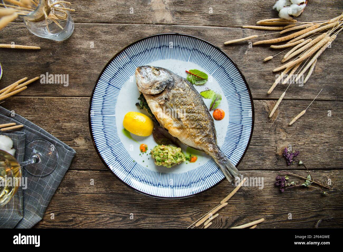 Grilled dorada fish on the wooden background Stock Photo - Alamy
