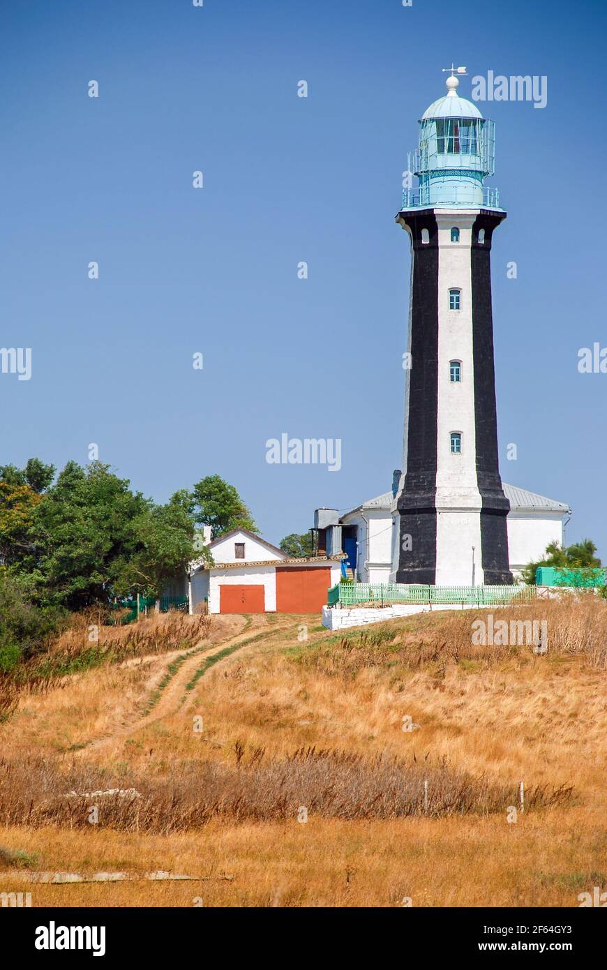 Lighthouse searchlight beam through sea air at night. Seascape at ...