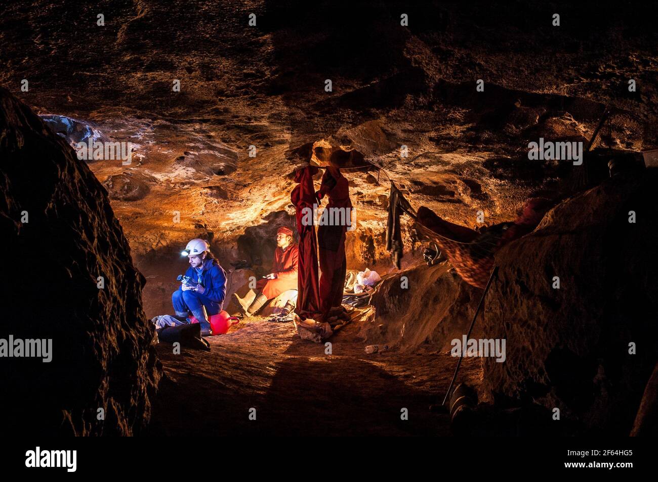 Speleologists resting in underground camp. Exploring caves are ...
