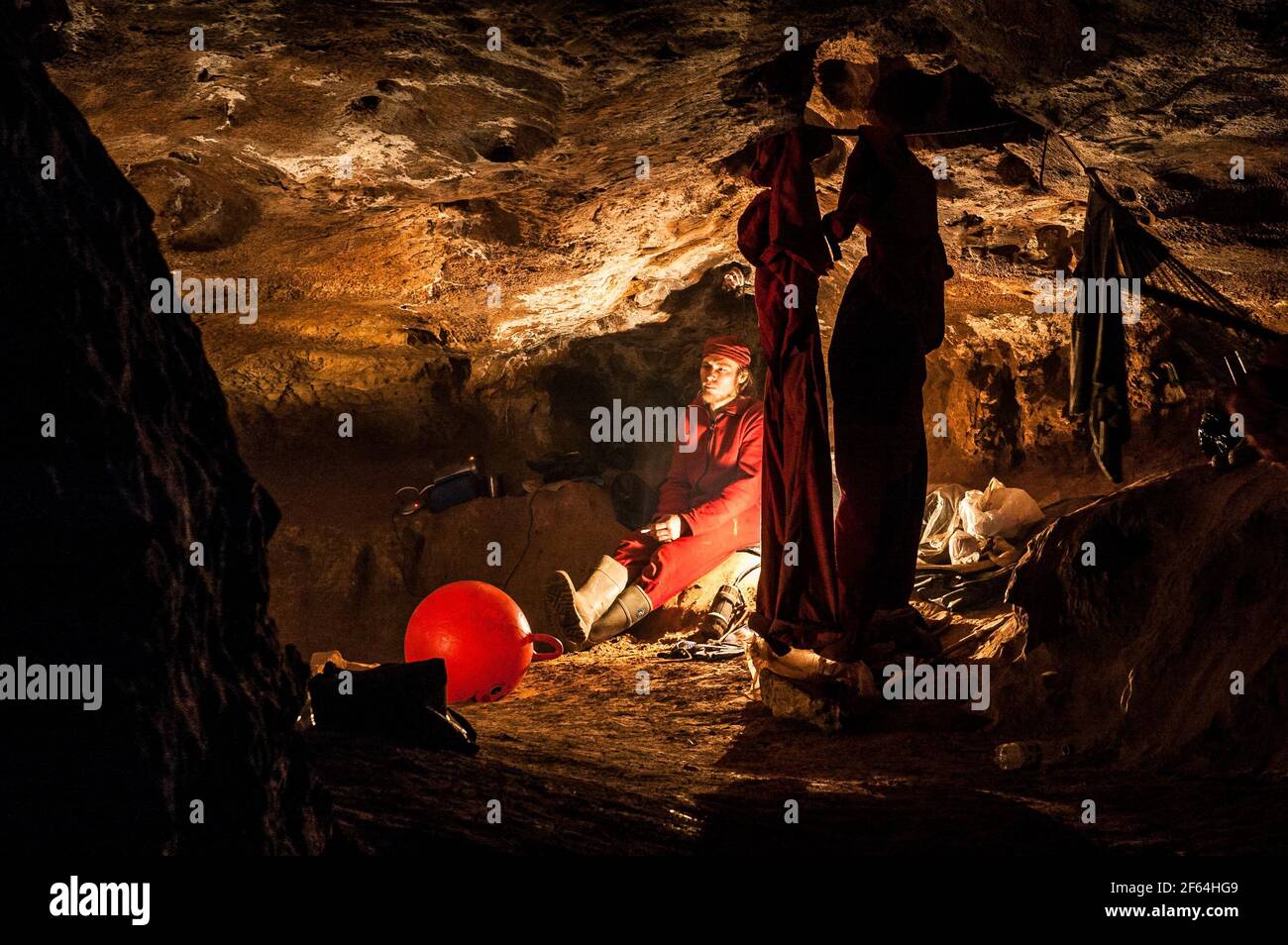 Speleologist resting in underground camp. Exploring caves are dangerous ...