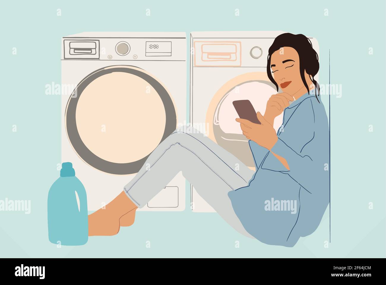 A pretty woman using phone while waiting the clothes are washed in the ...