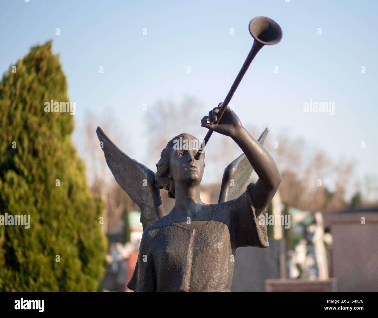 bronze statue of angel, divine messenger, playing the trumpet of ...