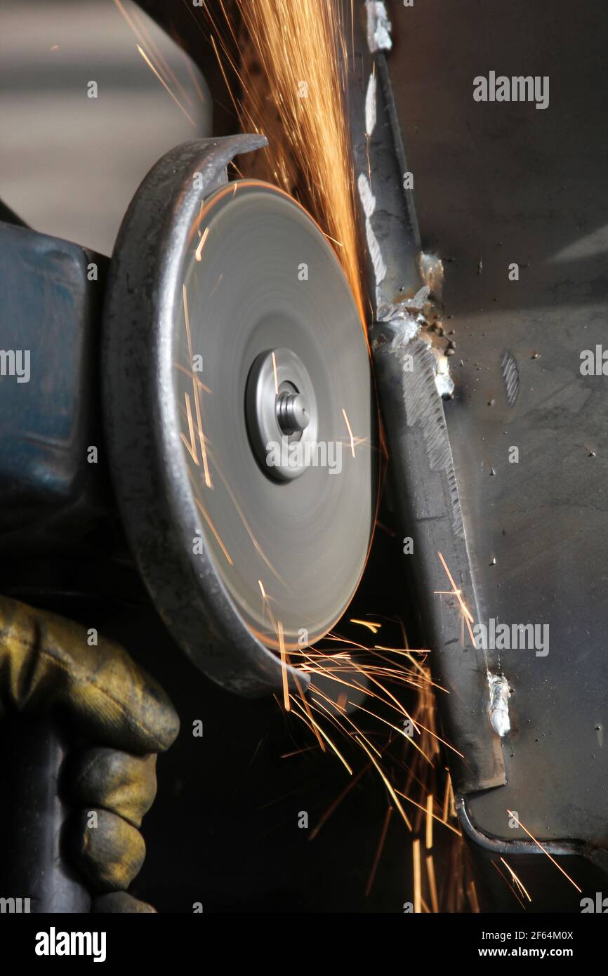 Steel cutter grinder and sparks in workshop Stock Photo - Alamy