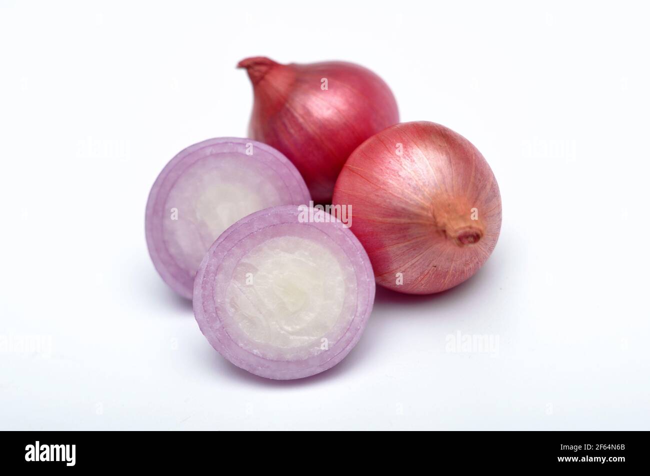 Three cloves of red onion on white background Stock Photo - Alamy