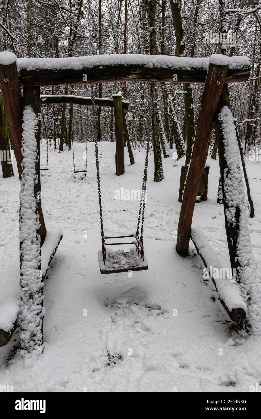 Wooden swing in winter forest playground with nobody around Stock Photo ...