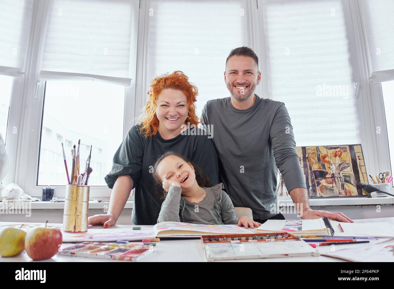Attractive caucasian family of artists: dad, mom and cute little kid ...