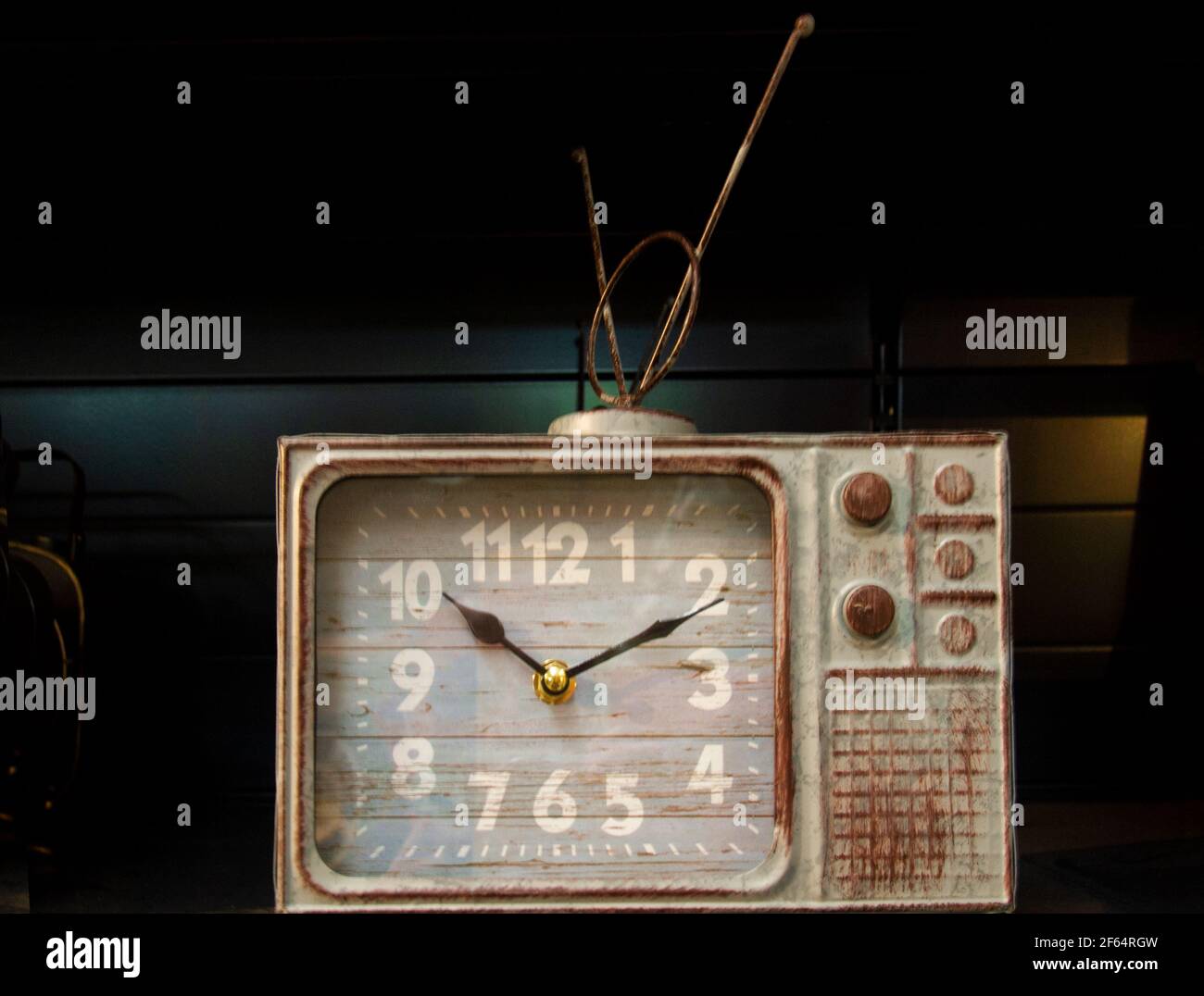 alarm clock with the appearance of a vintage television,dark background ...