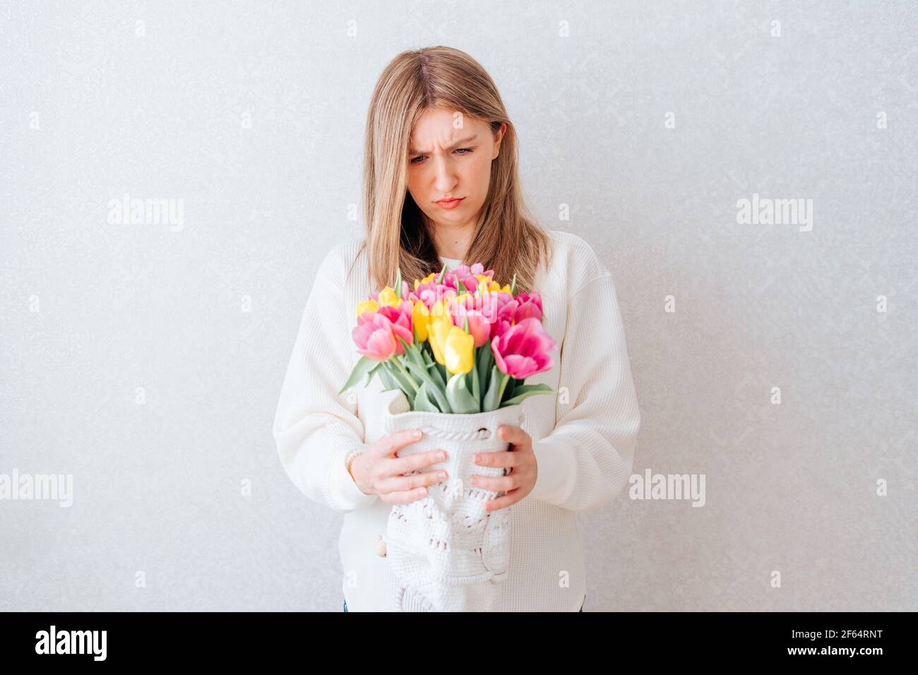 Sad woman holding tulips Stock Photo - Alamy