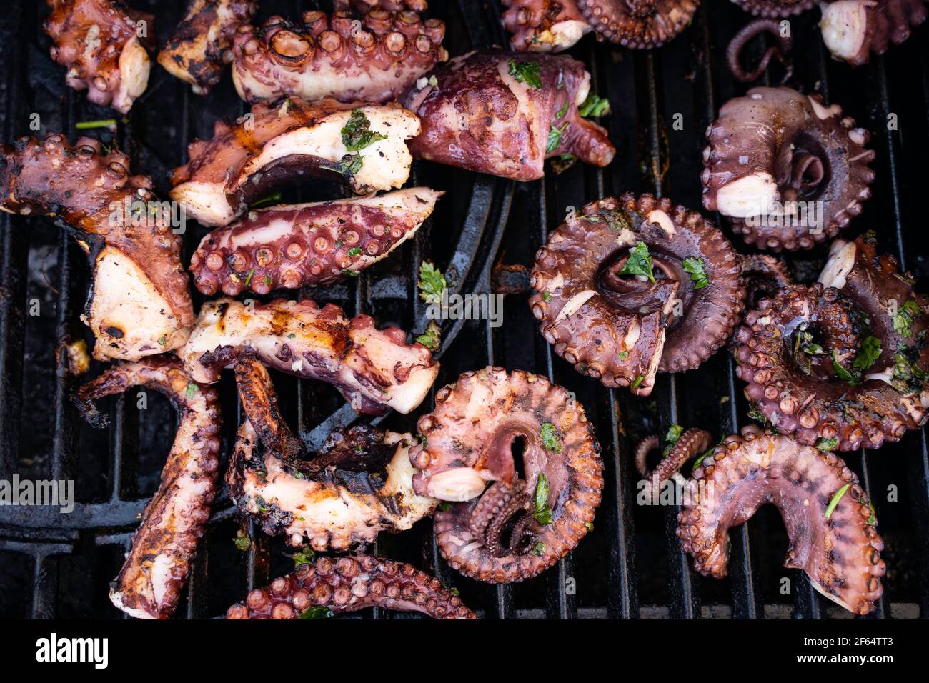 Cooking octopus on a barbeque grill Stock Photo - Alamy