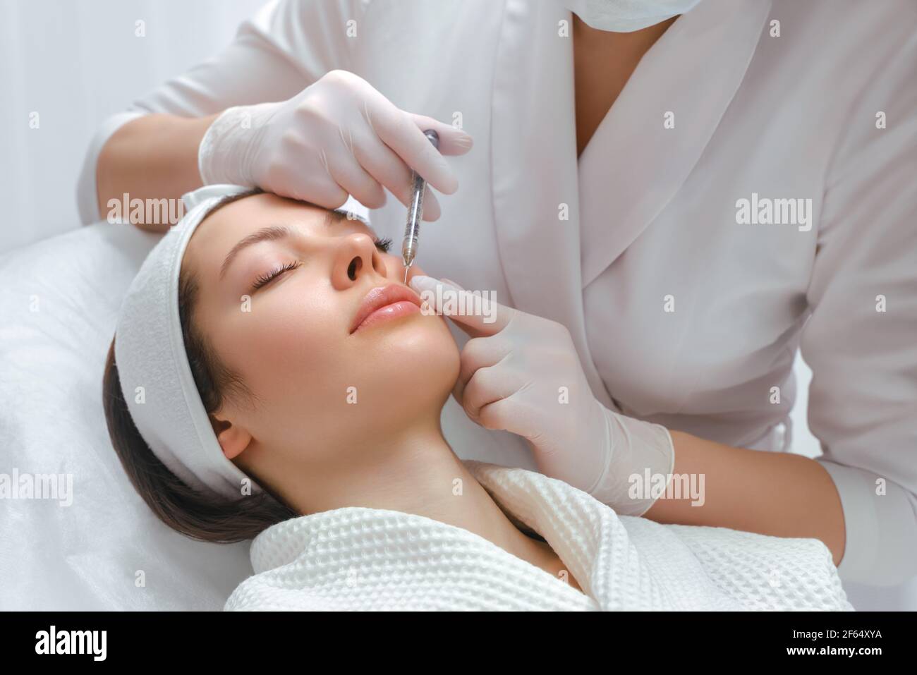 Lip augmentation and correction procedure in a cosmetology salon. The ...