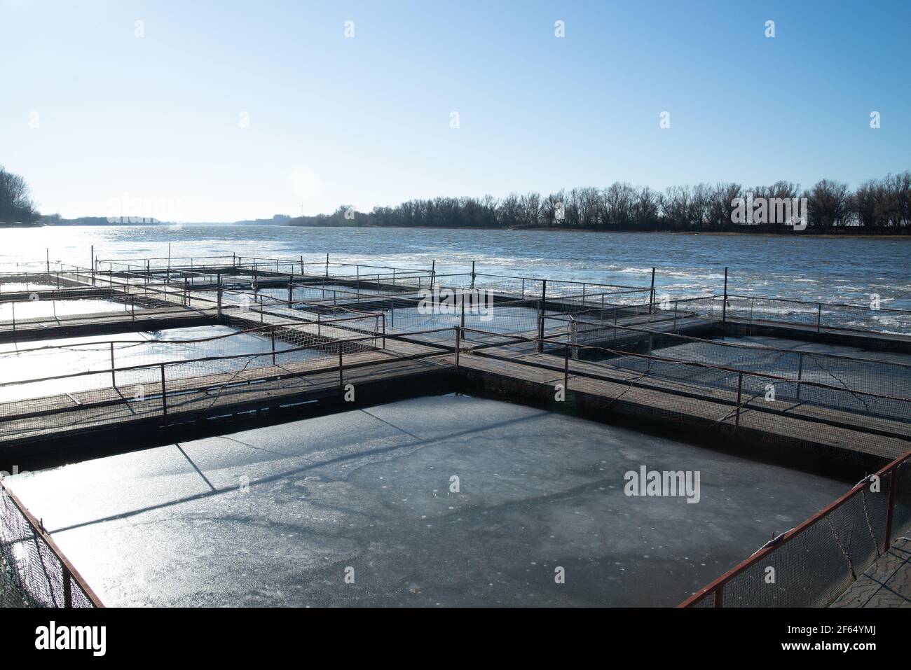 Cages for fish farming in the natural river Stock Photo - Alamy