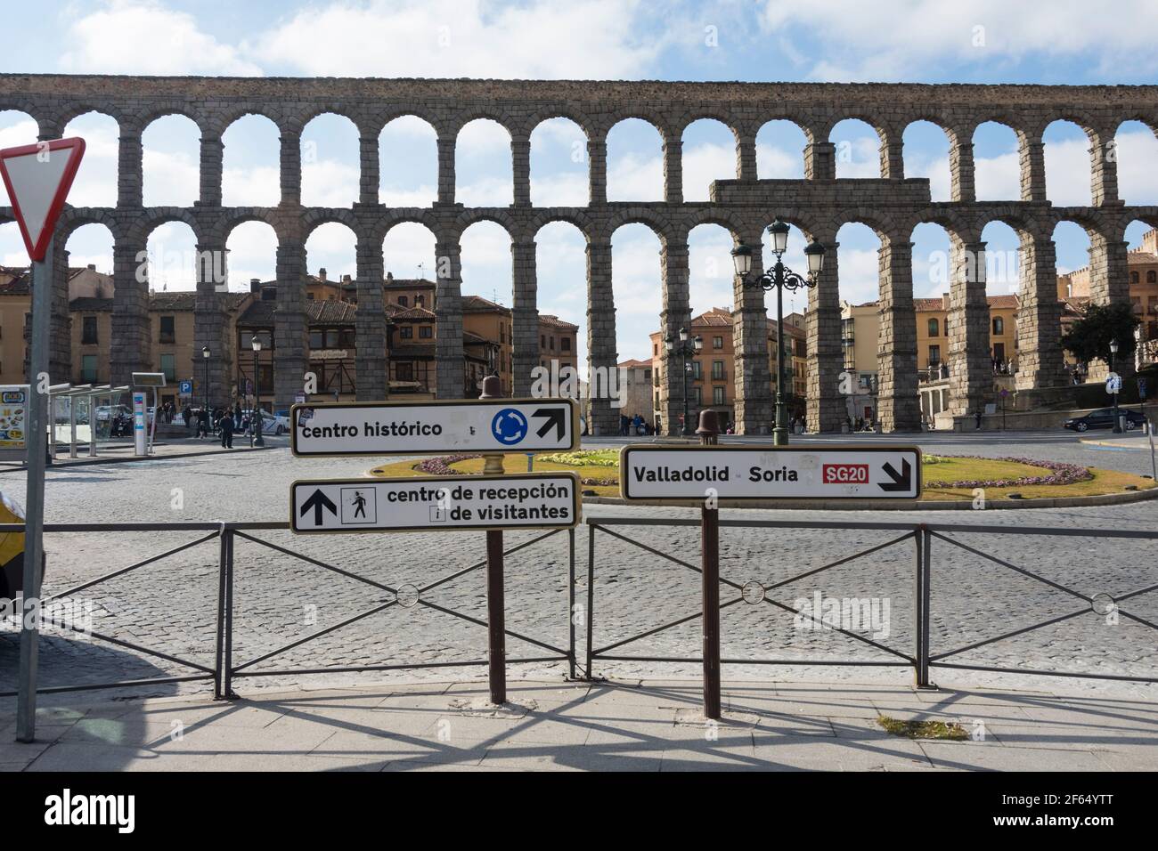 Direction signs at a roundabout near the Roman aqueduct of Segovia ...