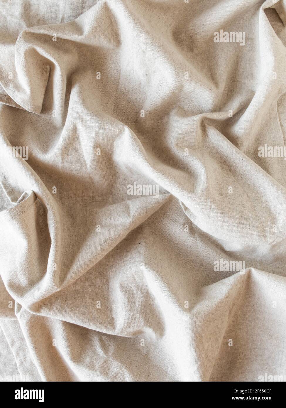 Natural textile linen with folds background. Top view Stock Photo - Alamy