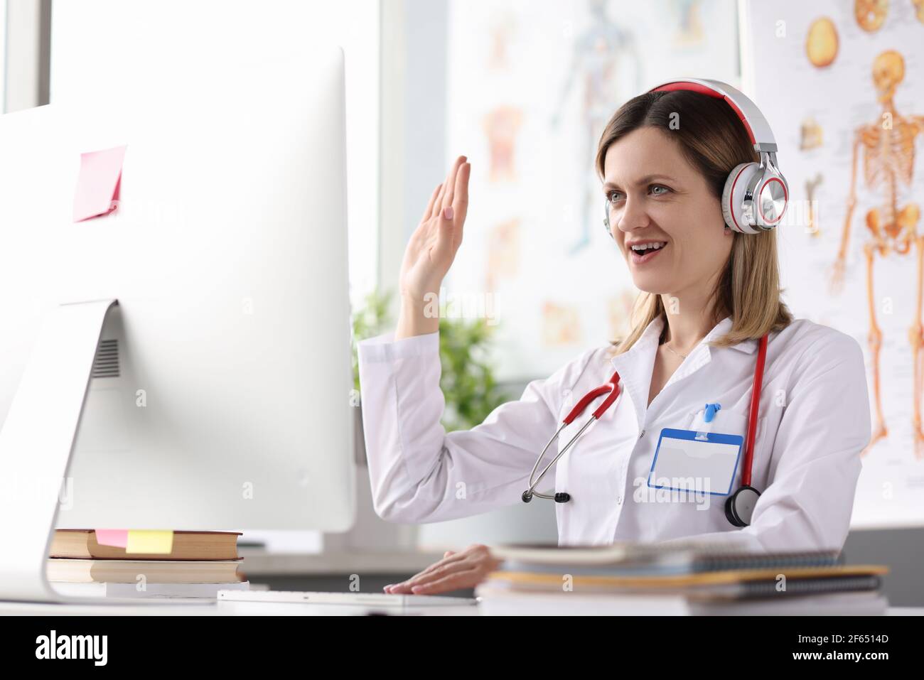 Doctor operator in call center at work desk Stock Photo - Alamy