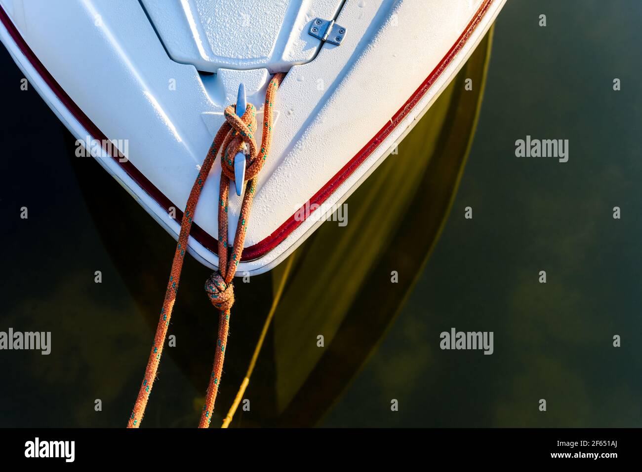 White yacht moored in port, bow and ropes close-up. morning top view of ...