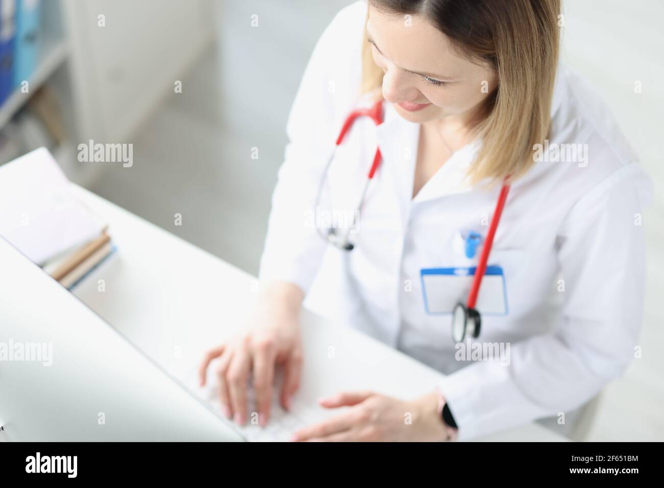 Doctor is typing on keyboard at desktop Stock Photo - Alamy