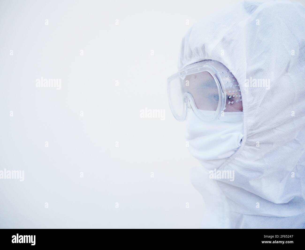 Side of face doctor or scientist in PPE suite uniform with copy space ...